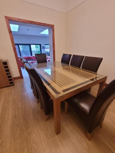 Oak and glass dining table with 8 chairs and storage unit For Sale in ...
